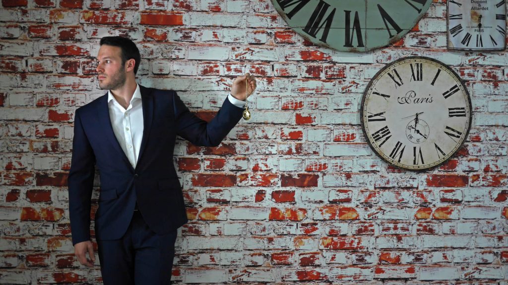 Aaron Calvert awaken show hypnotist holding pocket watch - Aaron ...